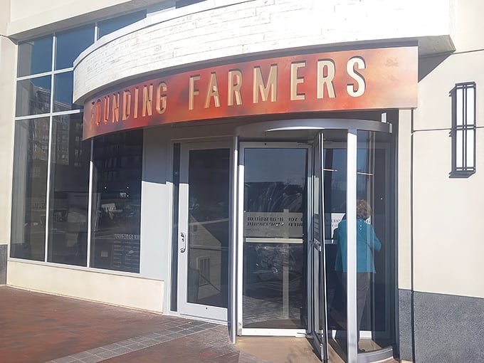 The curved awning and bold red lettering of Founding Farmers beckons like a culinary lighthouse in Potomac's upscale landscape. Farm-to-table paradise awaits.
