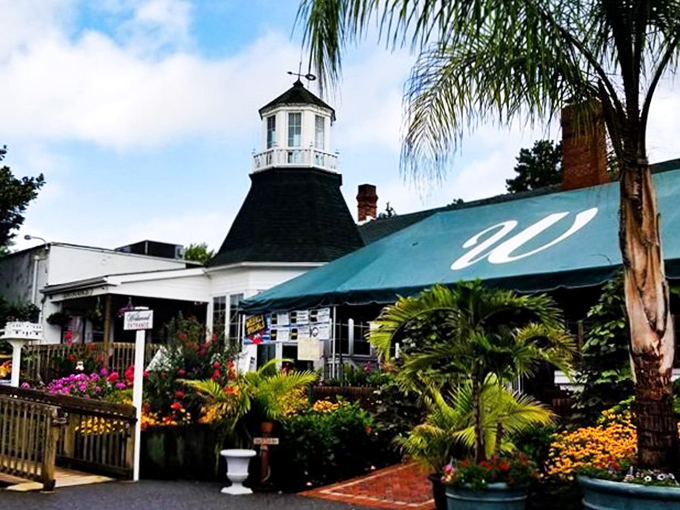 The lighthouse-inspired cupola welcomes diners like a culinary beacon, promising delicious adventures against a backdrop of Maryland's dreamy sunset skies.