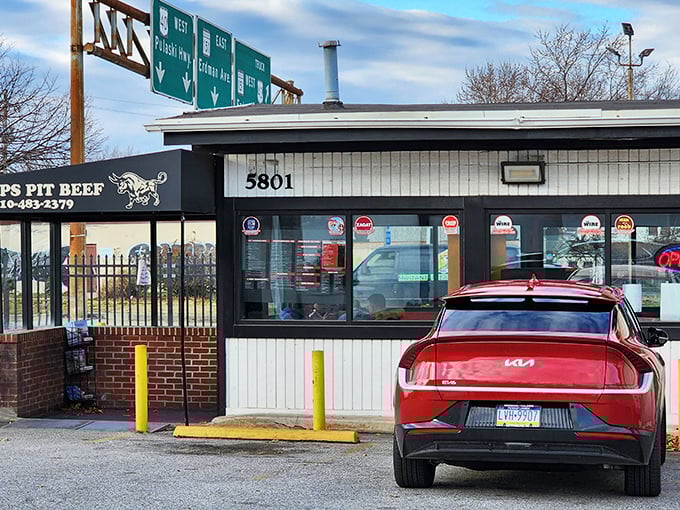 The unassuming exterior of Chaps Pit Beef stands like a beacon for barbecue pilgrims. Highway signs above remind you this is a destination worth exiting for.