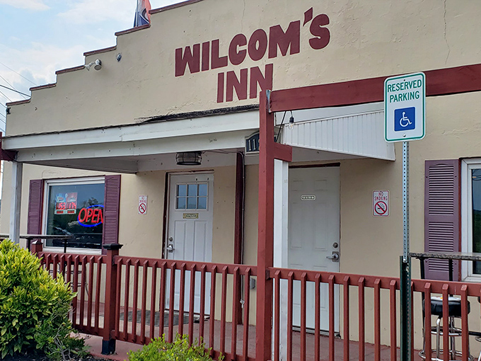 The unassuming exterior of Wilcom's Inn proves once again that culinary treasures often hide behind modest facades. That burgundy railing practically whispers, "Come on in, hungry traveler."