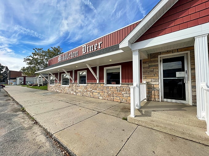 The classic red exterior of Middleton Diner stands like a beacon of comfort food promise against Michigan's ever-changing skies.