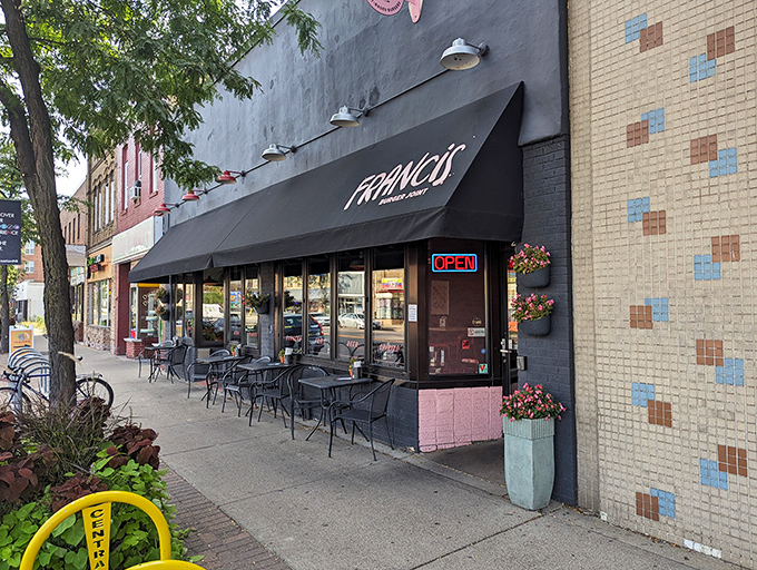 Francis Burger Joint's sleek black exterior beckons hungry passersby with its minimalist charm and promise of burger perfection ahead.