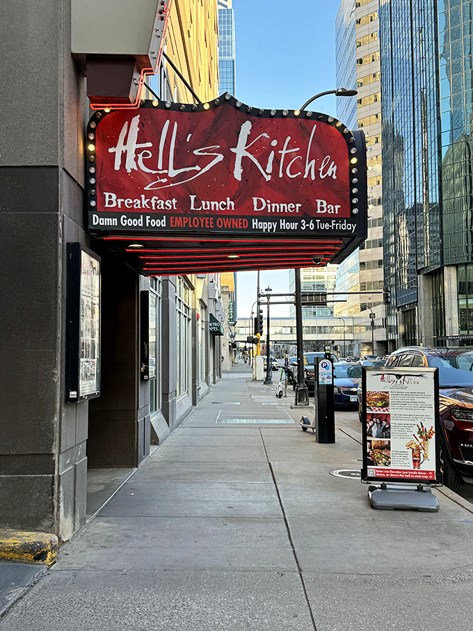 The entrance to culinary rebellion: Hell's Kitchen's bold red signage promises "Damn Good Food" &ndash; a Minneapolis institution that delivers on its devilish declaration.
