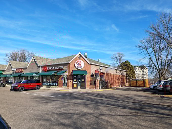 Welcome to BBQ paradise! Q Fanatic's exterior promises smoky delights, with its cheerful pig-and-cow logo acting as a meaty bat-signal for hungry patrons.