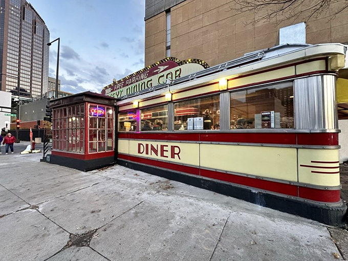 Mickey's iconic red and cream exterior stands like a time capsule on St. Paul's street corner, beckoning hungry travelers with its neon promise of comfort food.