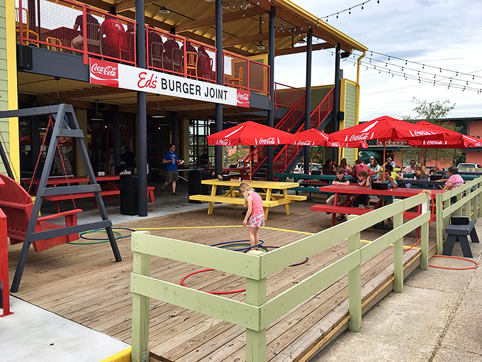 Ed's Burger Joint welcomes you with a playful exterior that promises good times ahead. The red staircase and string lights create an instant vacation vibe.