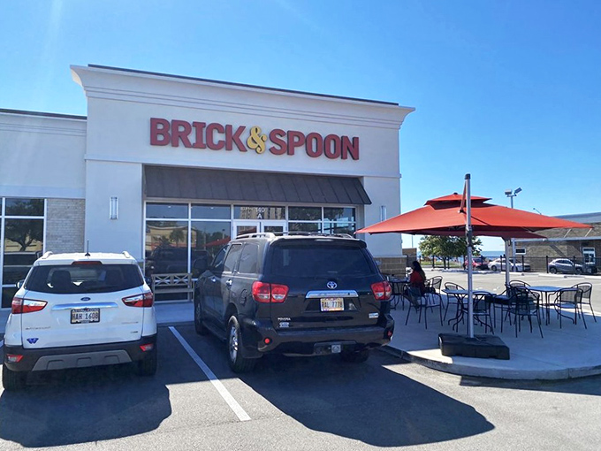 The red signage of Brick & Spoon gleams like a beacon for breakfast lovers. The patio beckons with promise of morning feasts and mimosa-fueled conversations.