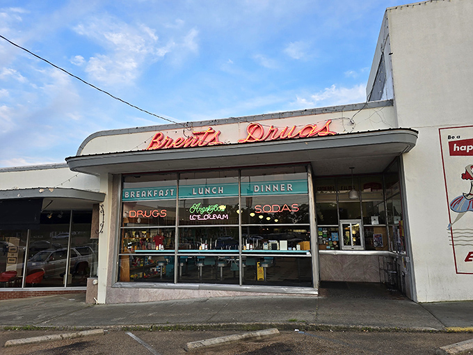 The classic storefront of Brent's Drugs beckons with its vintage neon sign, promising a taste of Mississippi nostalgia alongside your breakfast. 