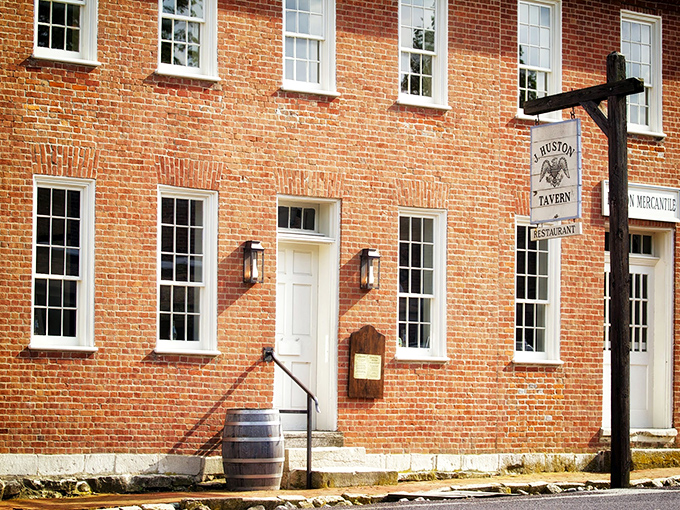 The historic red brick exterior of J. Huston Tavern stands proudly since 1834, making it the oldest continuously operating restaurant west of the Mississippi. 