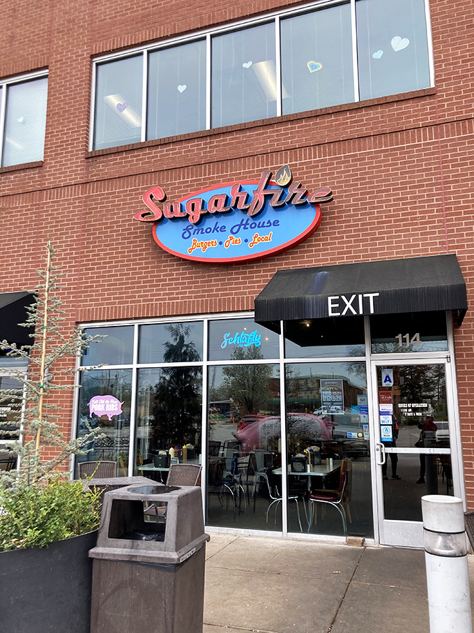 The brick-and-mortar temple of smoke beckons with its cheerful blue sign and red neon "BARBECUE" promise&mdash;a siren call to hungry travelers.