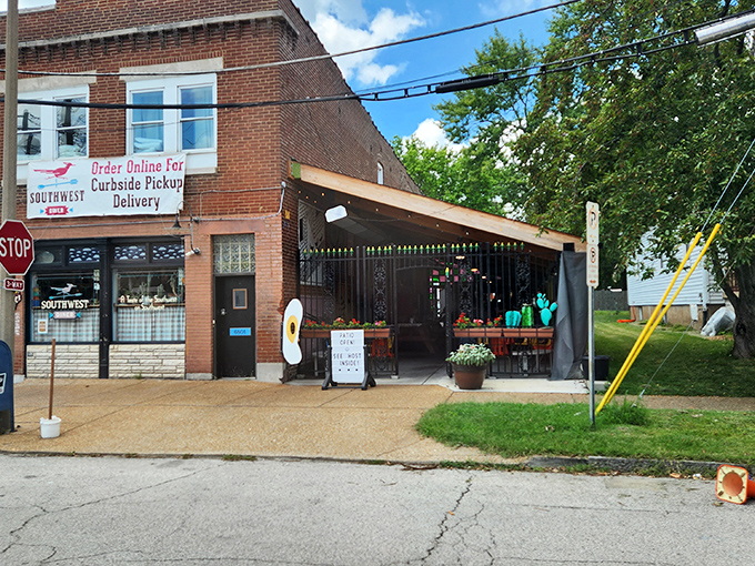 The unassuming brick exterior hides a southwestern flavor explosion within, where the patio's colorful chairs hint at the vibrancy waiting inside.