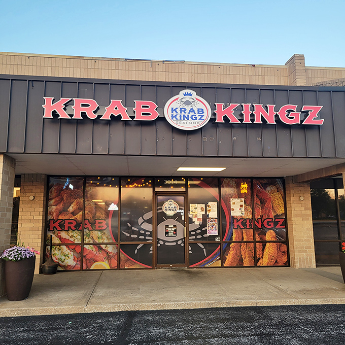 The bright red Krab Kingz sign glows like a beacon in the night, promising seafood treasures within this unassuming strip mall location.