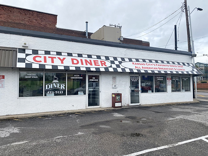 The classic white brick exterior with black and white striped awning stands like a time capsule on this Kansas City corner, beckoning hungry patrons with its humble charm. 