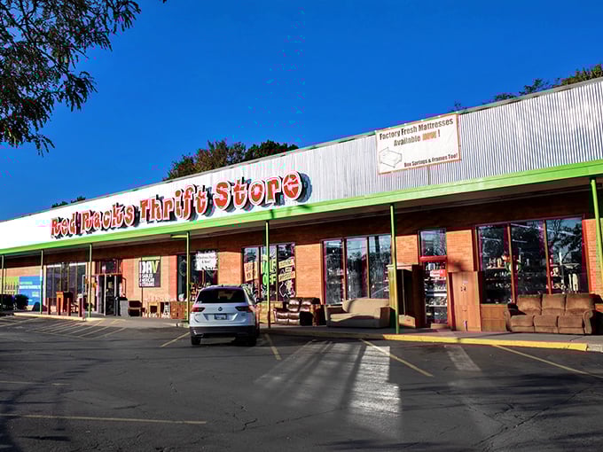 The bright red signage promises treasure within these walls, where bargain hunters and do-gooders unite in the pursuit of secondhand glory. 
