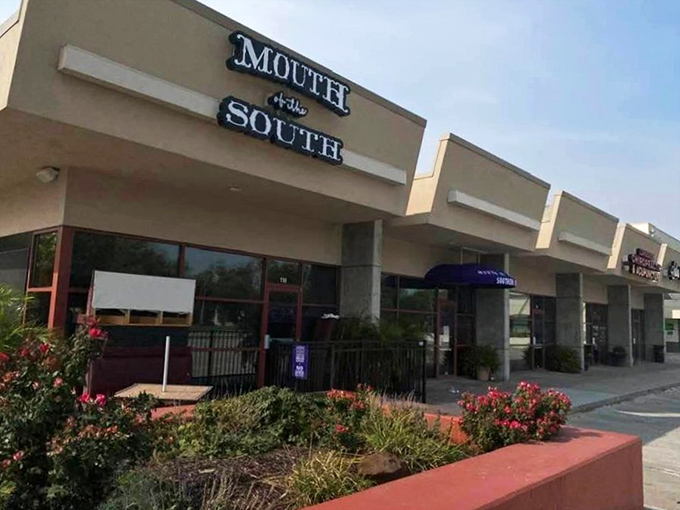 Those vibrant purple umbrellas are like beacons of flavor, signaling that this unassuming Omaha storefront houses serious Southern magic.