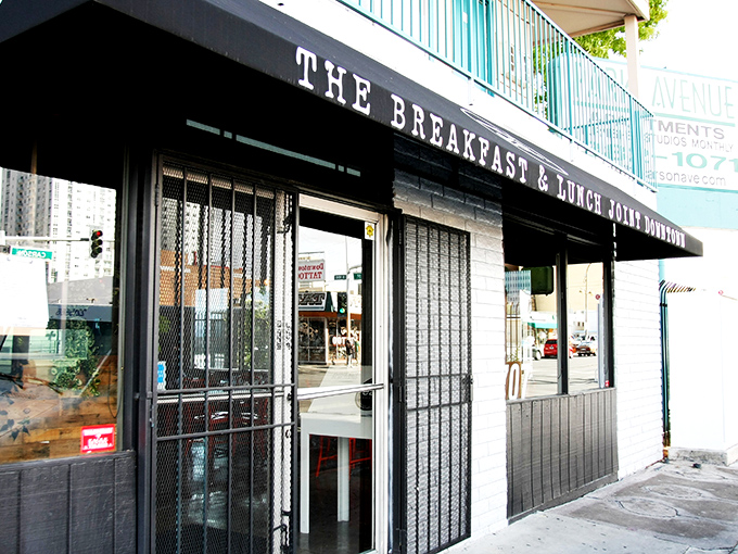 A modest storefront with a wooden bench that whispers, "The best culinary experiences often hide behind the simplest facades." Downtown Las Vegas's best-kept breakfast secret awaits.