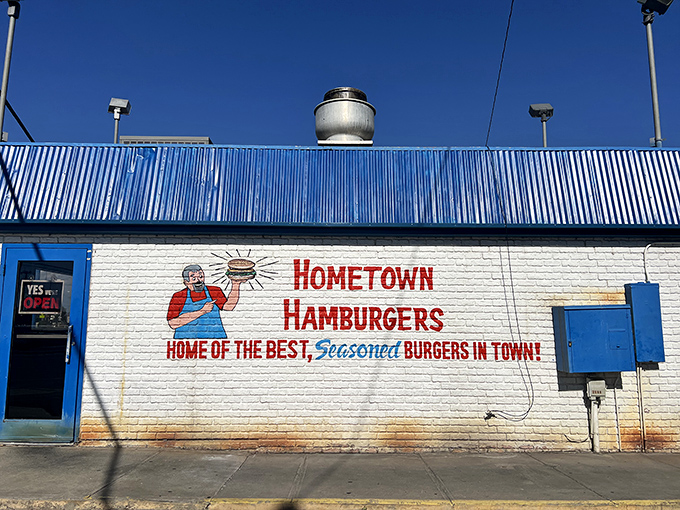 The blue-roofed burger sanctuary beckons with its no-nonsense promise: "Home of the best, seasoned burgers in town." No argument here.