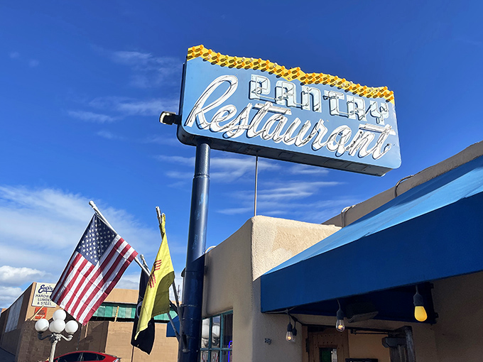 The neon glow of The Pantry's sign against the twilight sky is like a culinary lighthouse guiding hungry souls to shore.