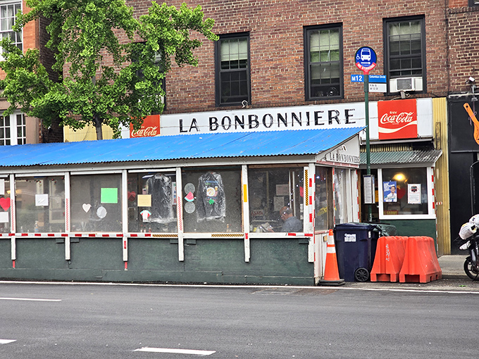 La Bonbonniere's weathered fa&ccedil;ade stands as a time capsule in the West Village, its vintage sign promising the holy trinity of comfort: burgers, snacks, and fountain treats.
