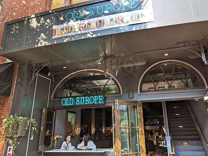 The blue neon glow of Old Europe's storefront beckons like a lighthouse for sugar-seekers in downtown Asheville. A quarter-century of sweet tradition awaits inside.