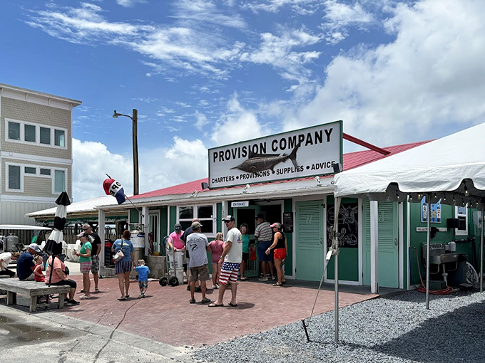 The unassuming entrance to seafood paradise &ndash; where that weathered fish sign promises more flavor than any fancy neon ever could. 