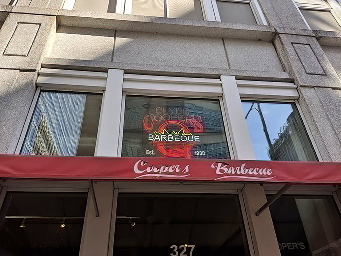 The neon glow of Clyde Cooper's storefront is like a lighthouse for hungry barbecue pilgrims, beckoning from downtown Raleigh since 1938.