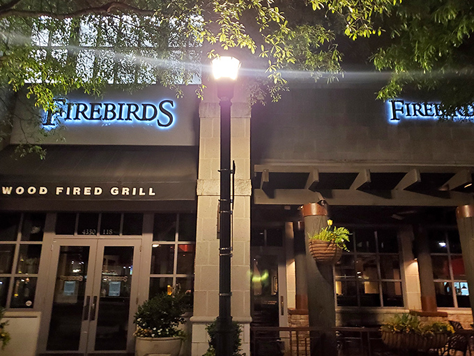 The blue glow of Firebirds beckons like a lighthouse for the hungry. At night, its warm exterior promises culinary adventures await inside.