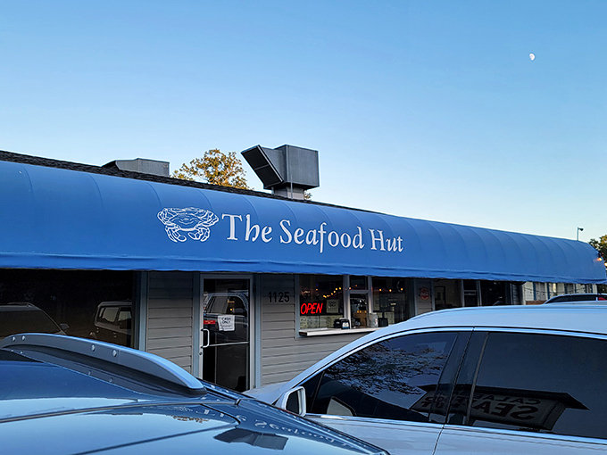 The iconic blue awning and simple sign of Calabash Seafood Hut stand as a beacon for seafood pilgrims. No fancy frills needed when the food speaks this loudly.