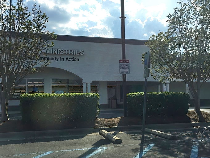 The welcoming fa&ccedil;ade of Dorcas Ministries invites treasure hunters with its clean white exterior and clear signage about donation procedures and store hours.