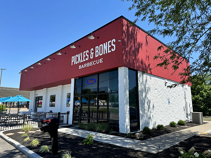 The bold red exterior of Pickles & Bones stands like a barbecue beacon in Milford, promising smoky treasures within those white-trimmed walls.