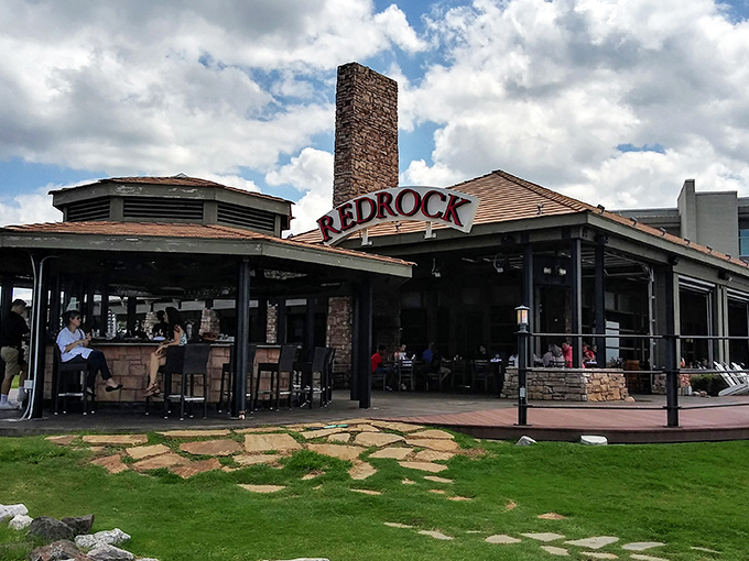 Stone meets sky at Redrock Canyon Grill, where that impressive chimney isn't just for show—it's the beacon that guides hungry Oklahomans home.
