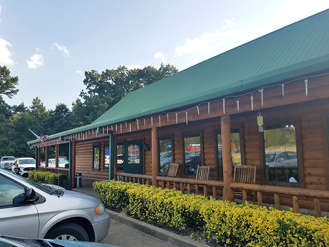 The log cabin exterior of Oaks Steak House welcomes hungry travelers with its distinctive green roof and rustic charm. Oklahoma hospitality in architectural form.