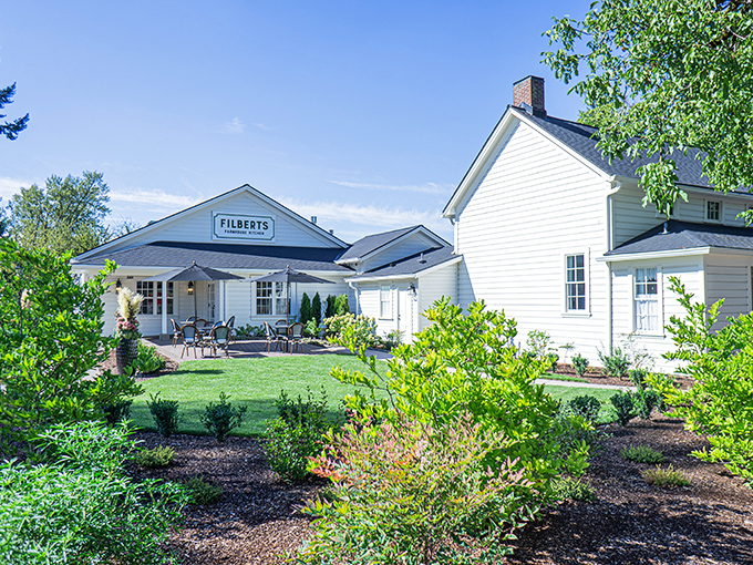 The classic white farmhouse exterior of Filberts beckons like an old friend, promising comfort food that'll make you forget your troubles at the door. 