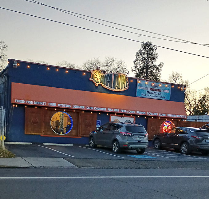 The bright blue exterior of The Wharf stands out like a maritime oasis in landlocked Medford, promising seafood treasures within those wooden-framed windows.