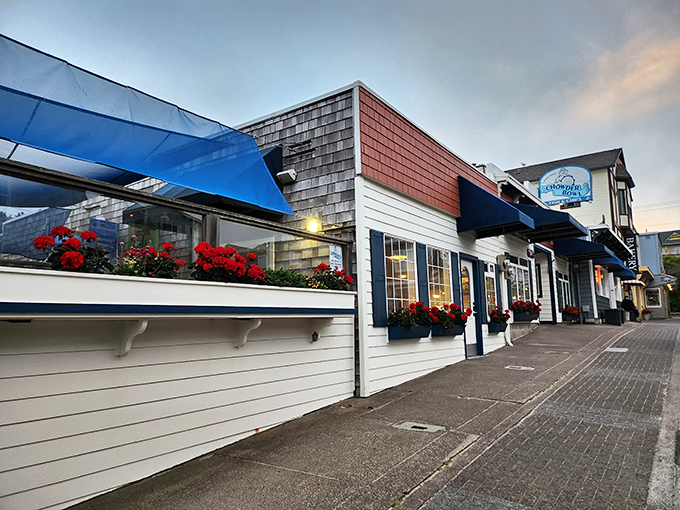 The classic coastal charm of The Chowder Bowl welcomes hungry travelers with its bright blue awnings and flower boxes—seafood paradise found!
