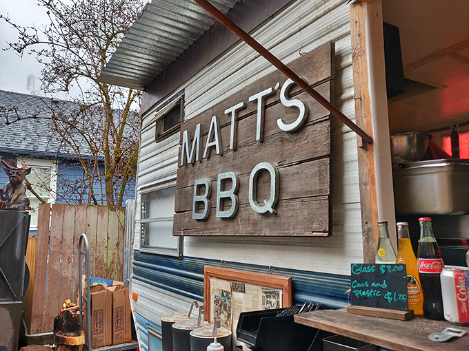 The covered dining area at Matt's BBQ offers the perfect blend of Portland's outdoor vibe and Texas-style communal eating. Picnic tables await hungry patrons.