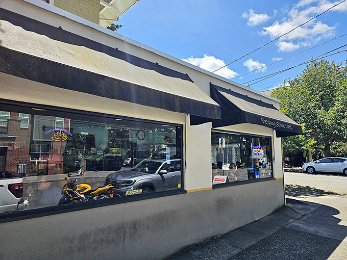 The unassuming storefront of Stepping Stone Caf&eacute;, with its simple black awning and neon "OPEN" sign, promises zero pretension and maximum flavor.