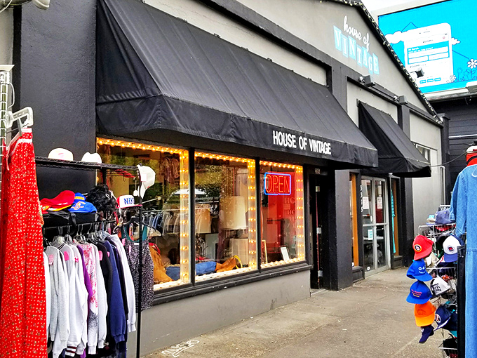 The unassuming storefront of House of Vintage beckons with colorful clothing racks outside, like a portal to decades past waiting to be explored.