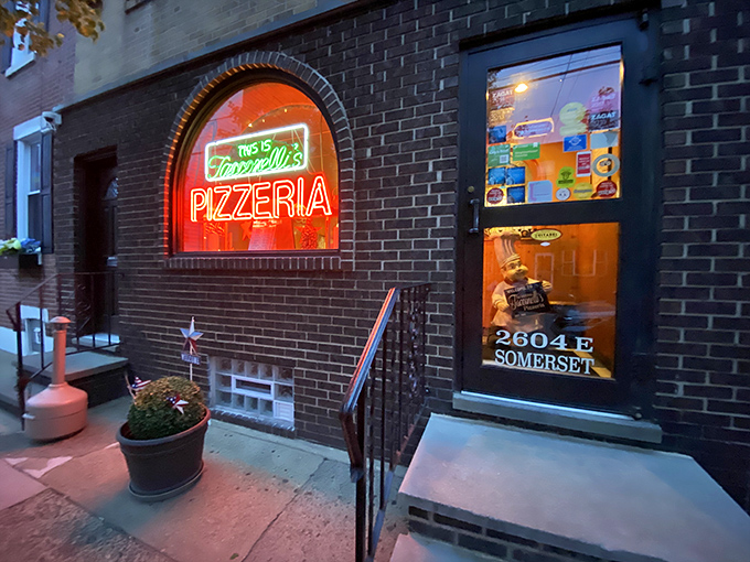 The neon glow of Tacconelli's sign beckons pizza pilgrims like a lighthouse for the carb-obsessed. Pizza paradise awaits behind that brick facade. 