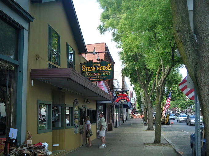 The charming yellow exterior of The Steak House stands proudly on Wellsboro's tree-lined main street, a beacon for hungry travelers seeking carnivorous bliss.