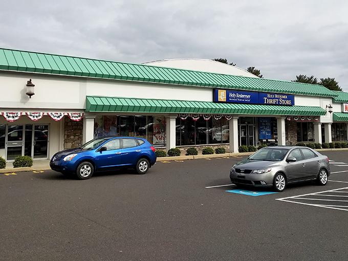 The distinctive green-trimmed exterior of Holy Redeemer Thrift Store stands like a treasure chest waiting to be opened, promising adventures in secondhand shopping. 