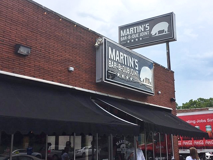 The red brick exterior of Martin's Bar-B-Que Joint beckons hungry pilgrims with its no-nonsense fa&ccedil;ade and the promise of smoky delights within.