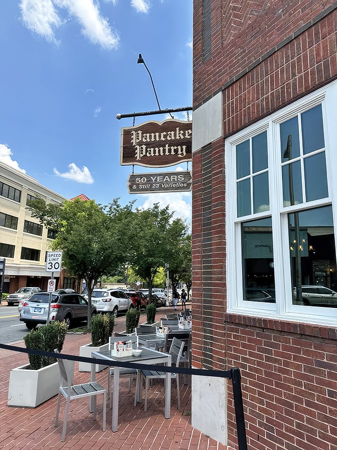 The iconic brick exterior of Pancake Pantry proudly displays its "50 Years & Still 23 Varieties" sign, a testament to perfecting rather than changing a good thing.
