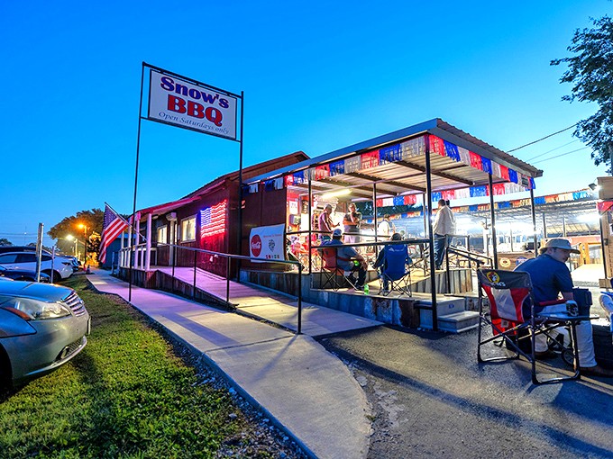 The unassuming exterior of Snow's BBQ under the Texas sky, where BBQ dreams come true before most people have their first cup of coffee.