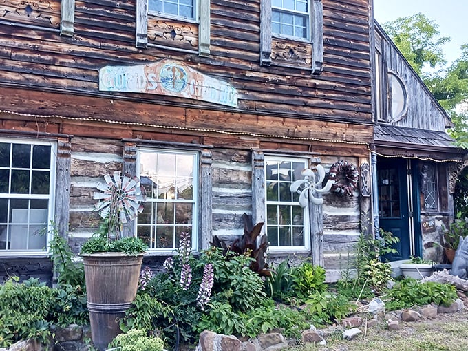 The Log House 1776 stands proudly in Wytheville, its weathered wooden exterior telling stories of centuries past while flowering wisteria adds a touch of romance.