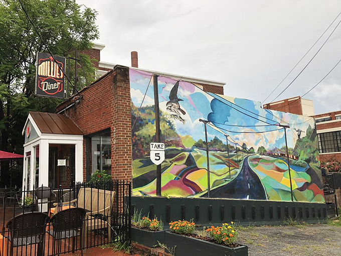 The unassuming brick exterior of Millie's Diner belies the culinary magic happening inside. That colorful mural isn't just decoration&mdash;it's a preview of the vibrant flavors awaiting you.