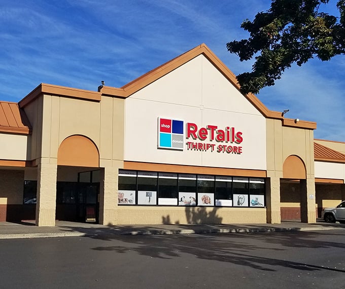 A rainbow arches over ReTails like nature's own "Open" sign, promising treasure hunters a pot of second-hand gold within those beige walls. 