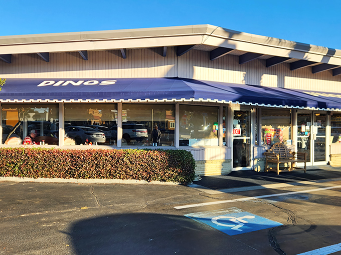 The unassuming blue awning of Dino's beckons like a breakfast lighthouse, guiding hungry souls through the morning fog of indecision.