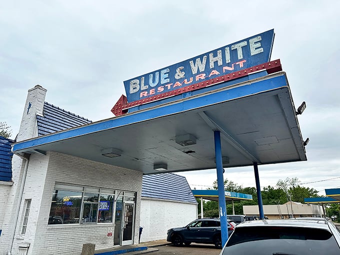 The iconic Blue & White sign stands like a beacon for hungry travelers, promising comfort food under that nostalgic gas station canopy.