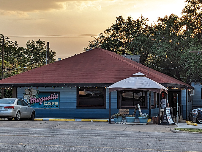 The iconic blue exterior of Magnolia Cafe stands as an Austin landmark, its welcoming porch and signature sign beckoning hungry pilgrims at all hours.